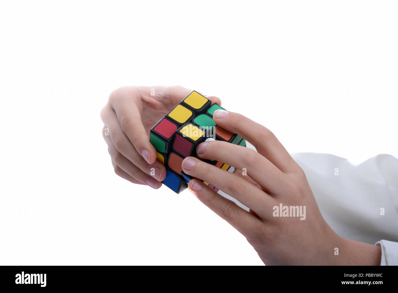 Child holding a Rubik's cube in hand on a white background Stock Photo ...