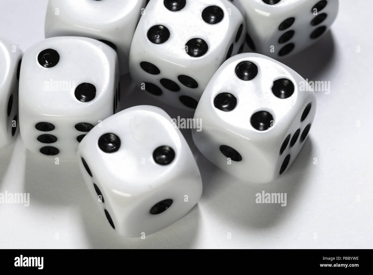 Macro shot of multiple dice on white background Stock Photo - Alamy