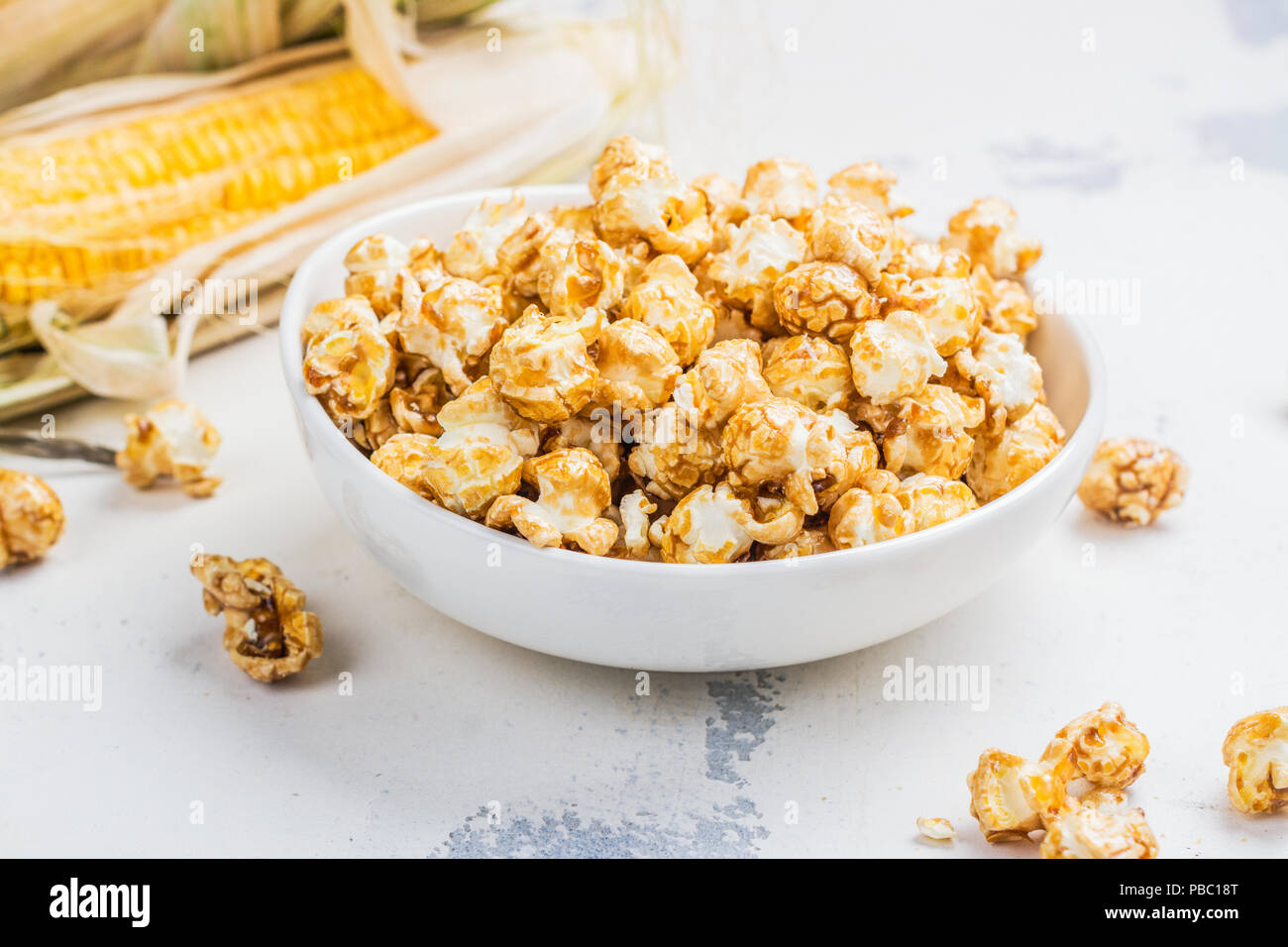 Caramel popcorn in a white bowl Stock Photo - Alamy