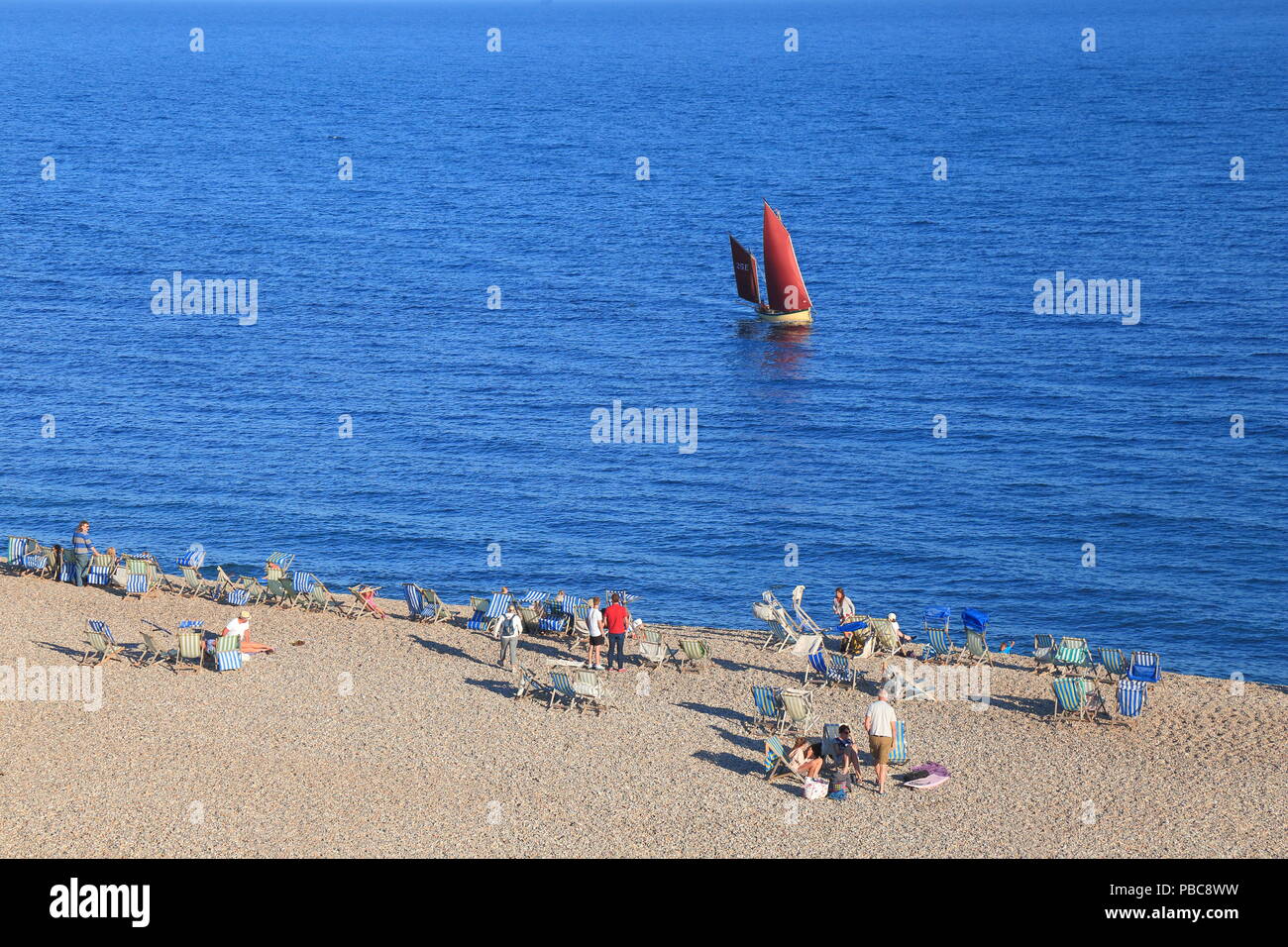 Tourists on the pebble beach in village of Beer in East Devon Stock ...