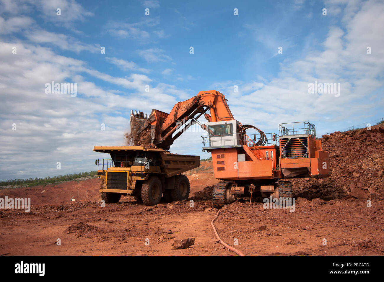 Truck is being loaded with ore at a mine site Stock Photo - Alamy