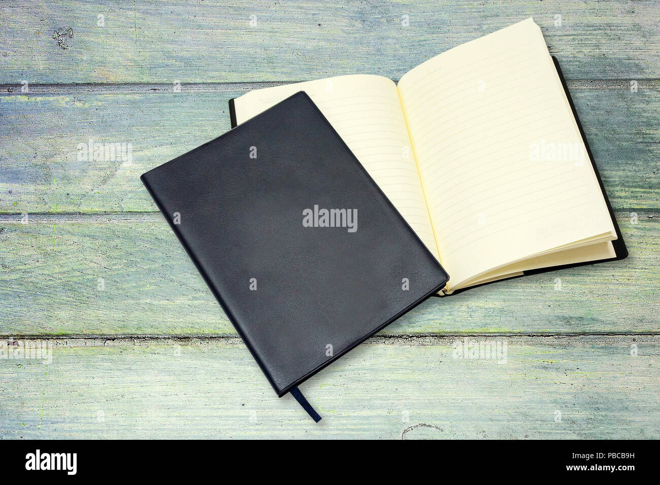 leather notebook and open notebook on blue wood background Stock Photo ...