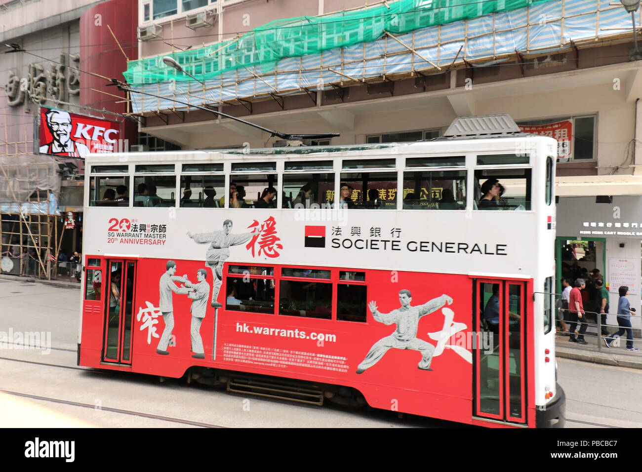 Famous tram on street of Hong Kong with passengers inside and people in ...