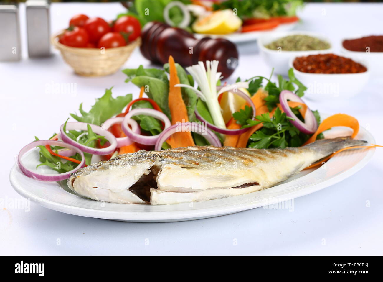 Grilled fish with vegetables Stock Photo - Alamy