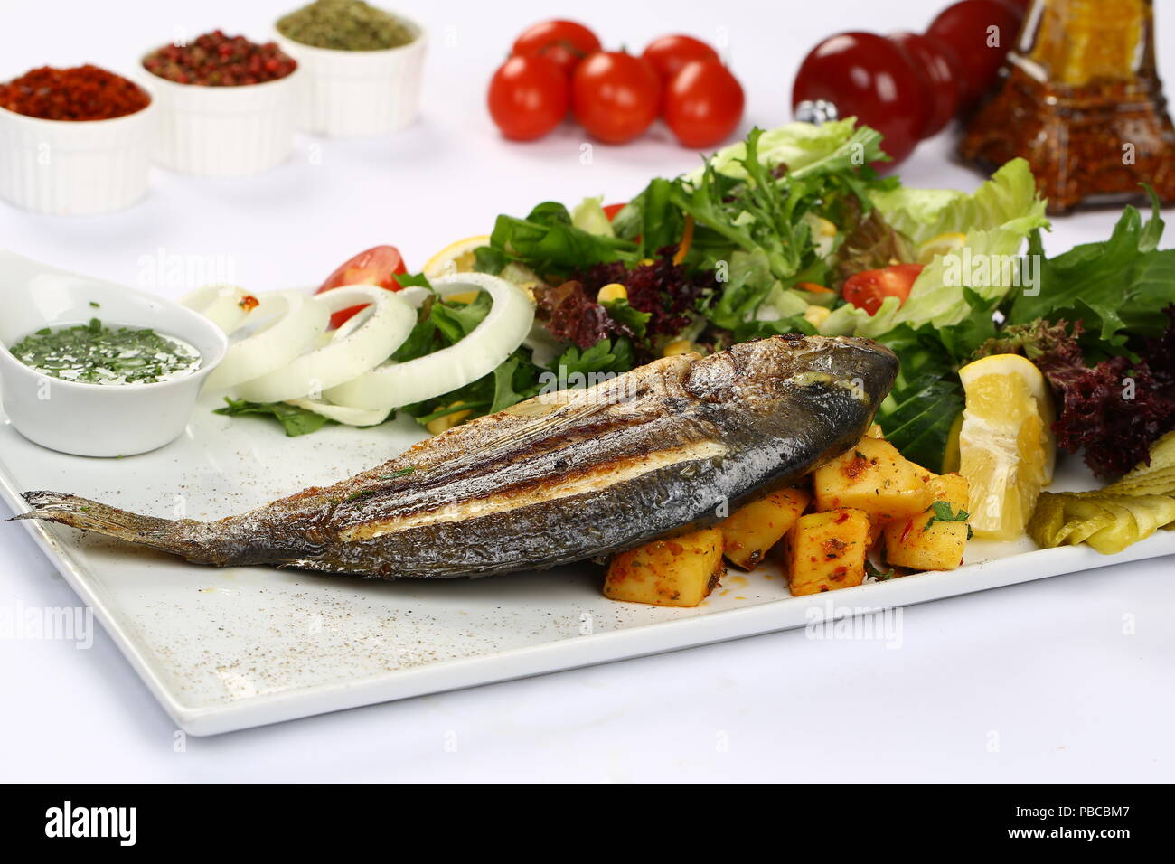Grilled fish with vegetables Stock Photo - Alamy