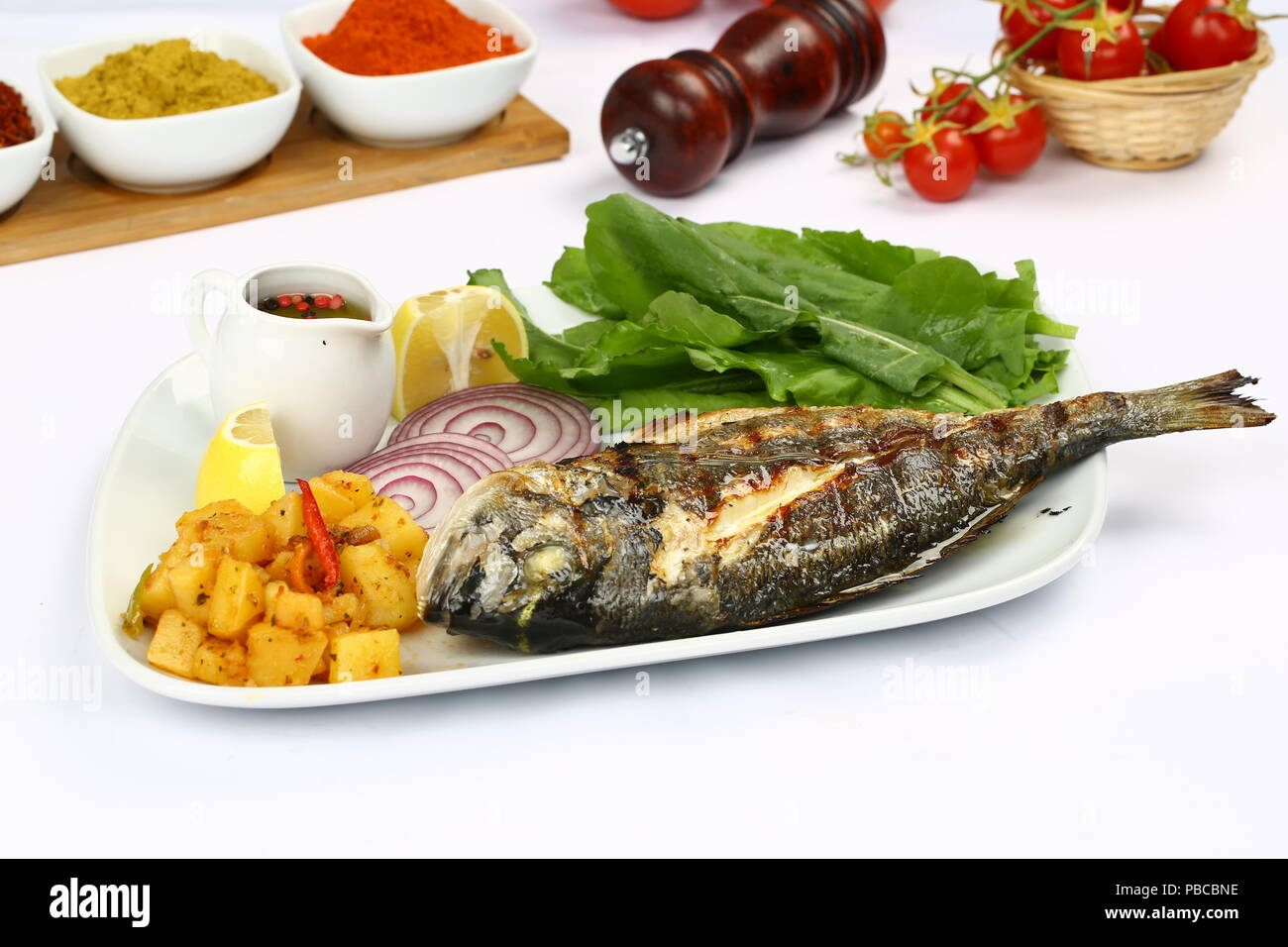 Grilled fish with vegetables Stock Photo - Alamy