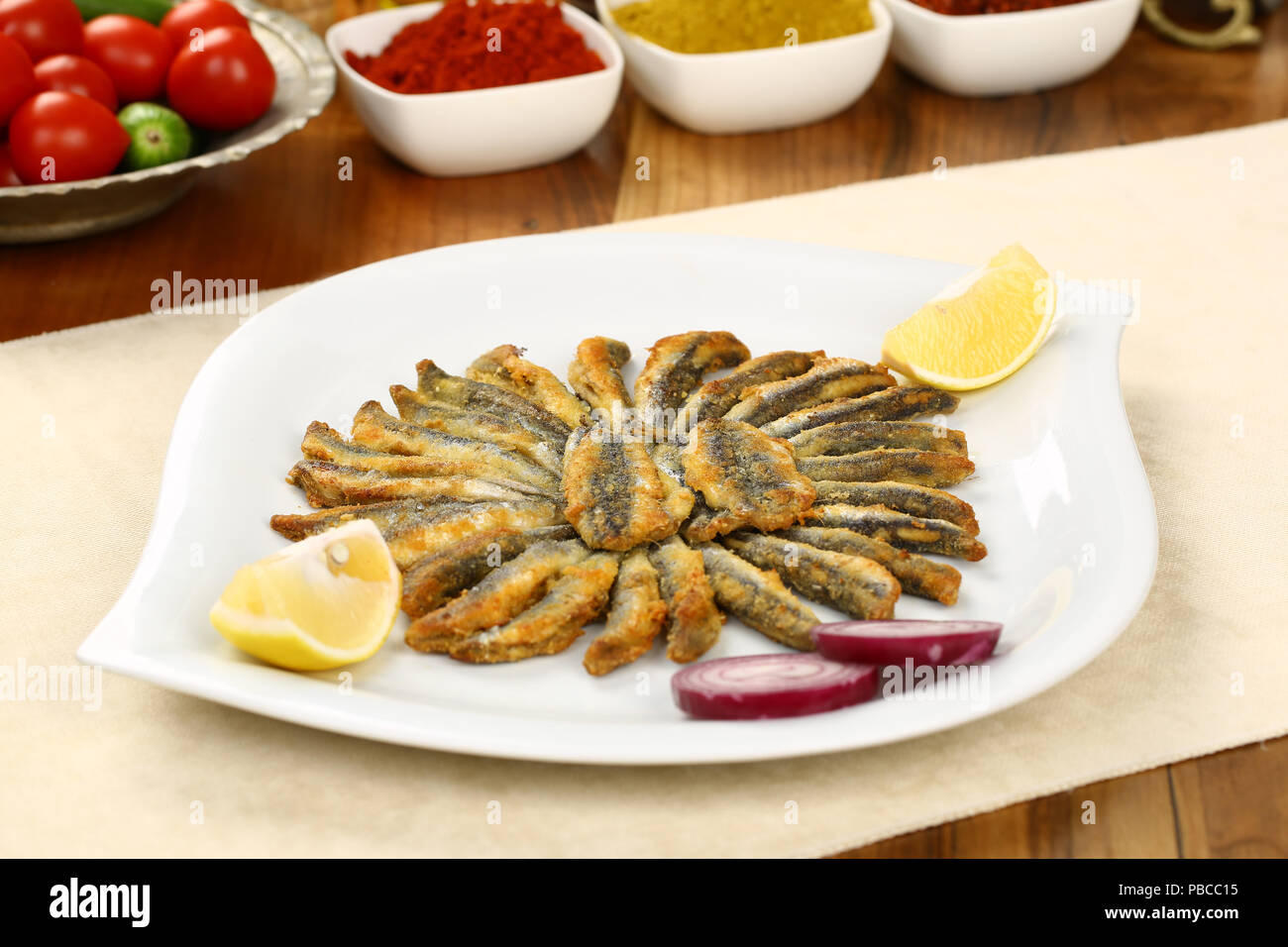 Grilled fish with vegetables - anchovy Stock Photo - Alamy