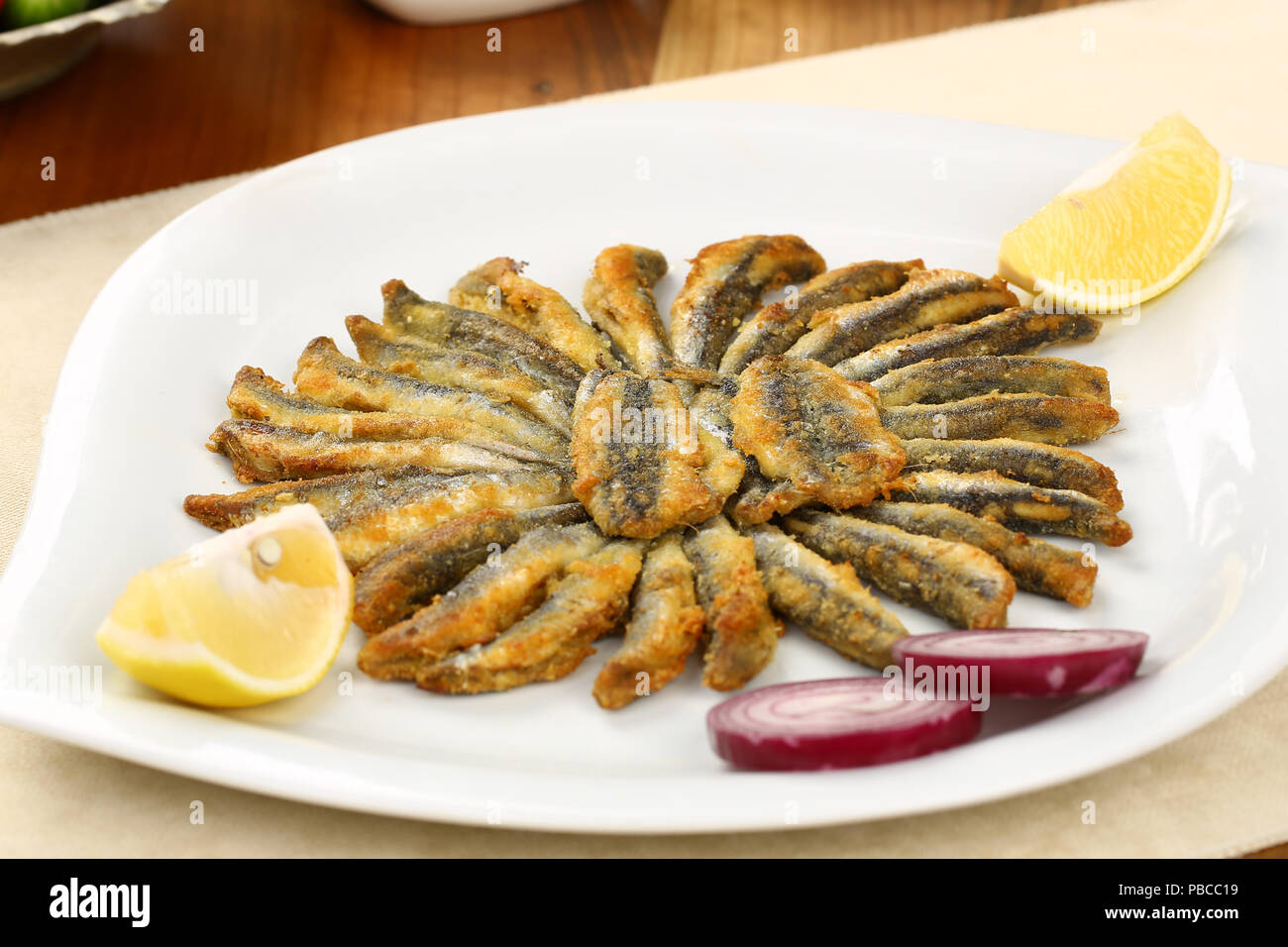 Grilled fish with vegetables - anchovy Stock Photo - Alamy