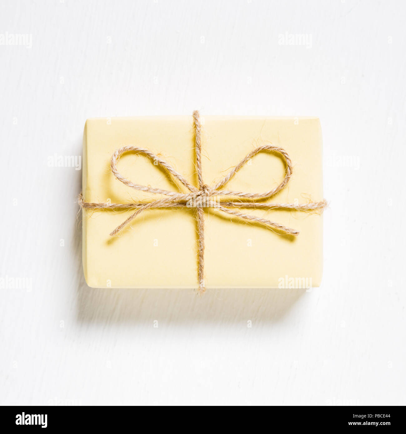 Yellow color gift box on white background Stock Photo - Alamy