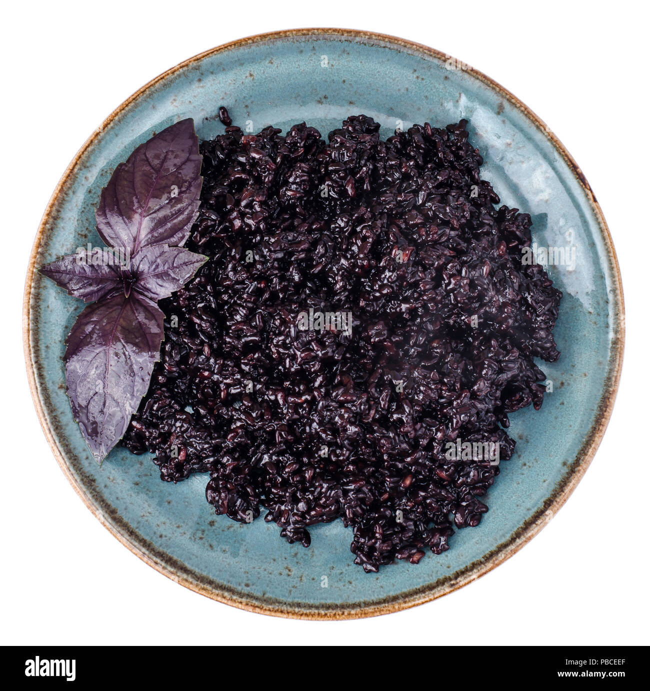 Cooked black rice on blue plate. Studio Photo Stock Photo - Alamy