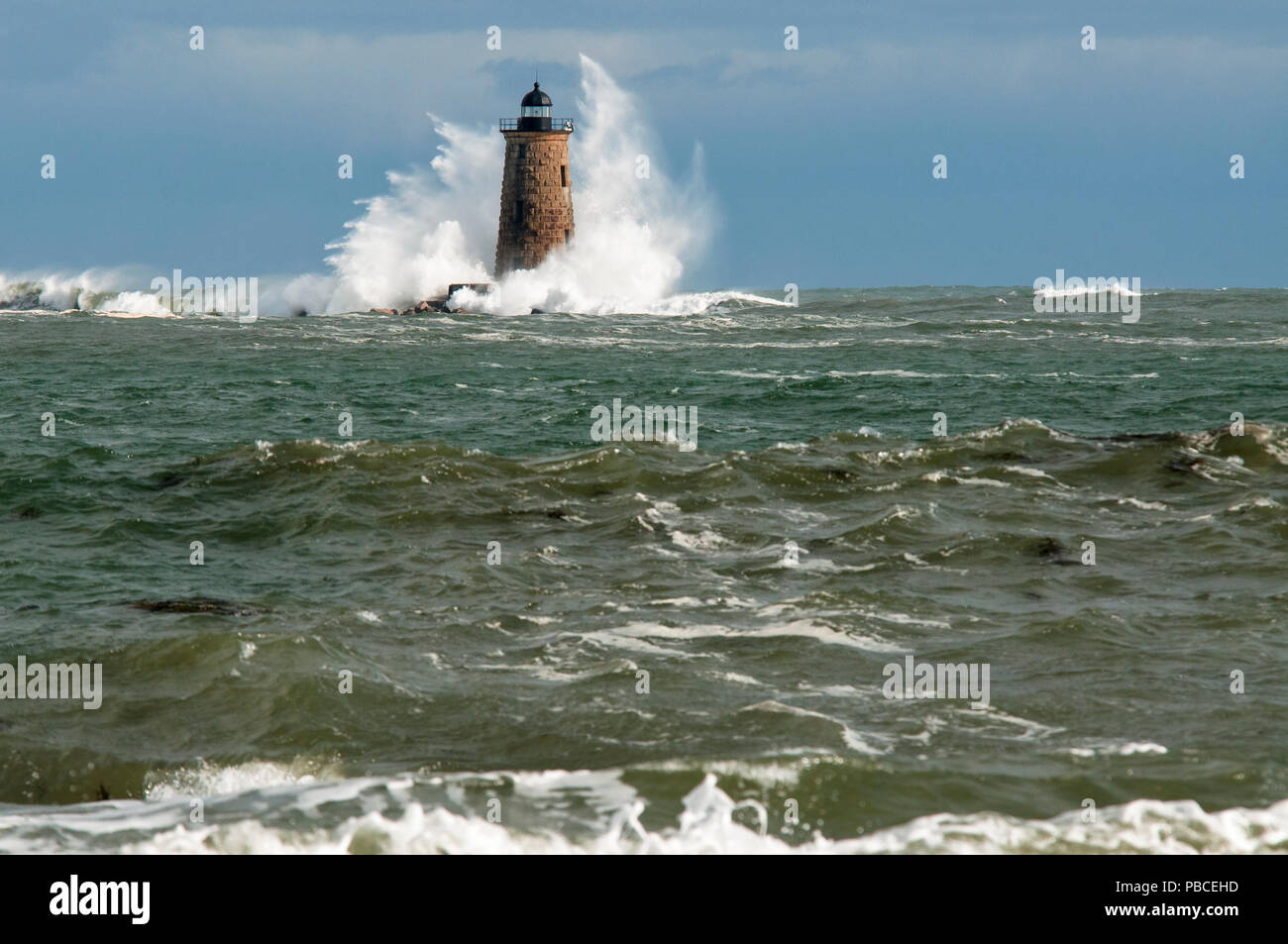 Giant waves surround stone lighthouse tower of Whalback light in Maine ...