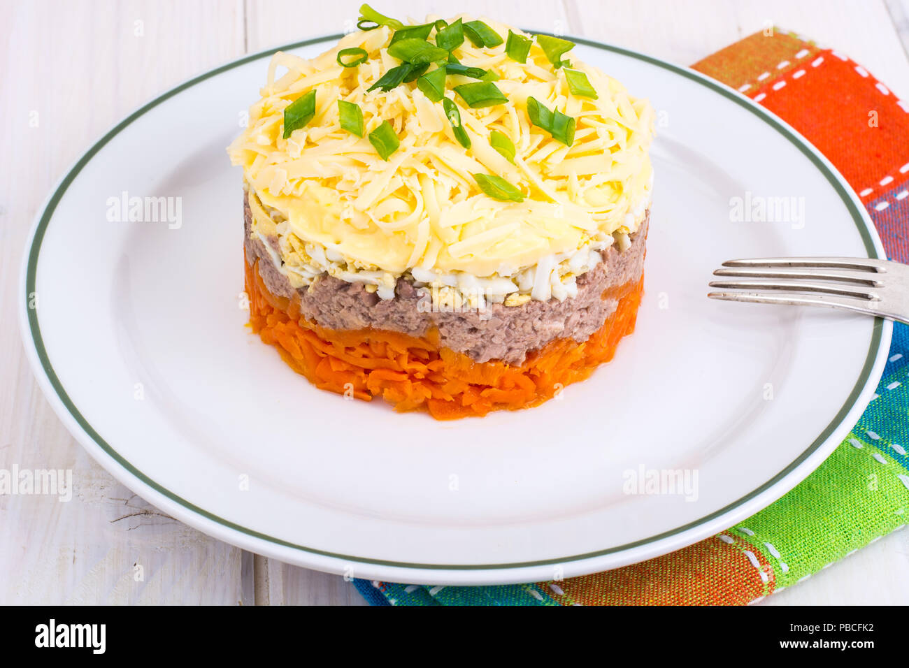 Portion salad with carrots on white wooden table. Studio Photo Stock ...