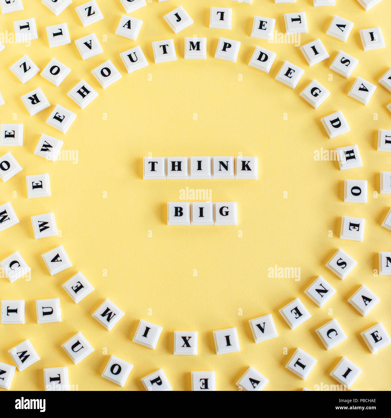 Plastic block cube with word THINK BIG and around scattered individual ...