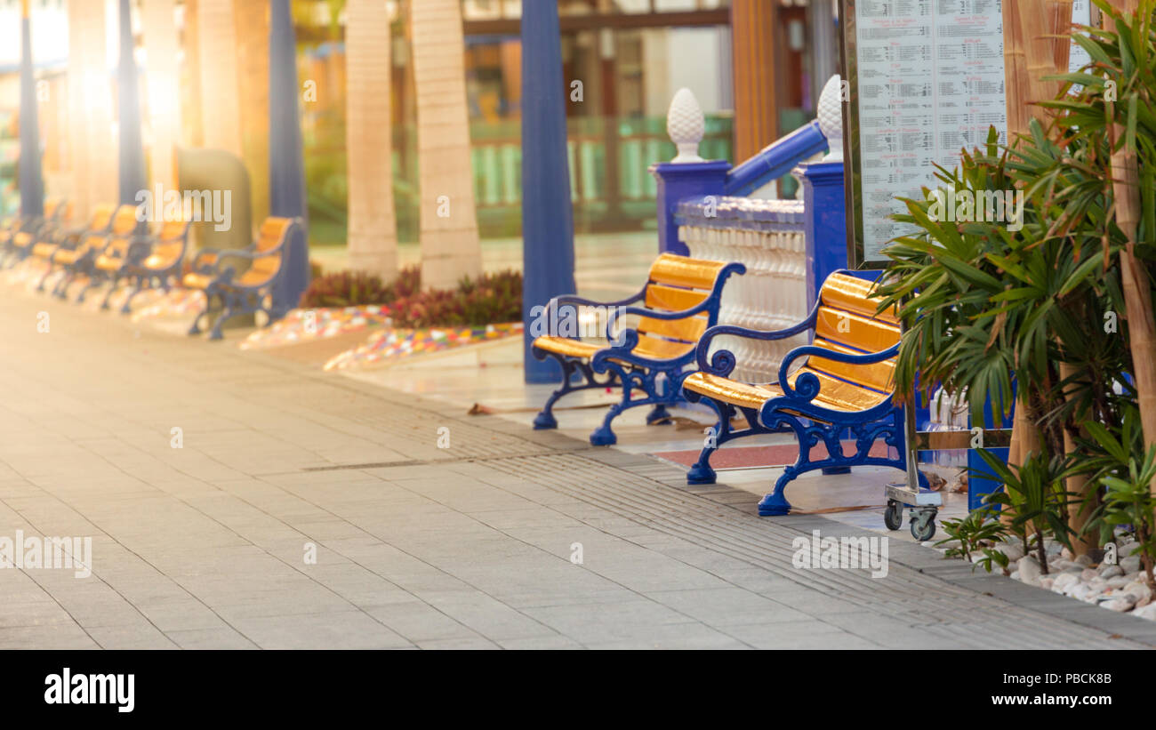 Coloured yellow and blue benches on promenade in tourist resort Stock ...