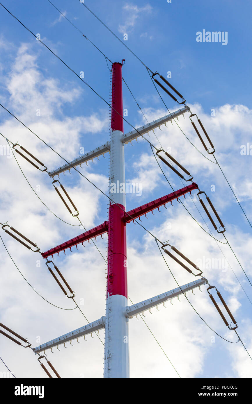 Red and white electric line pole Stock Photo - Alamy