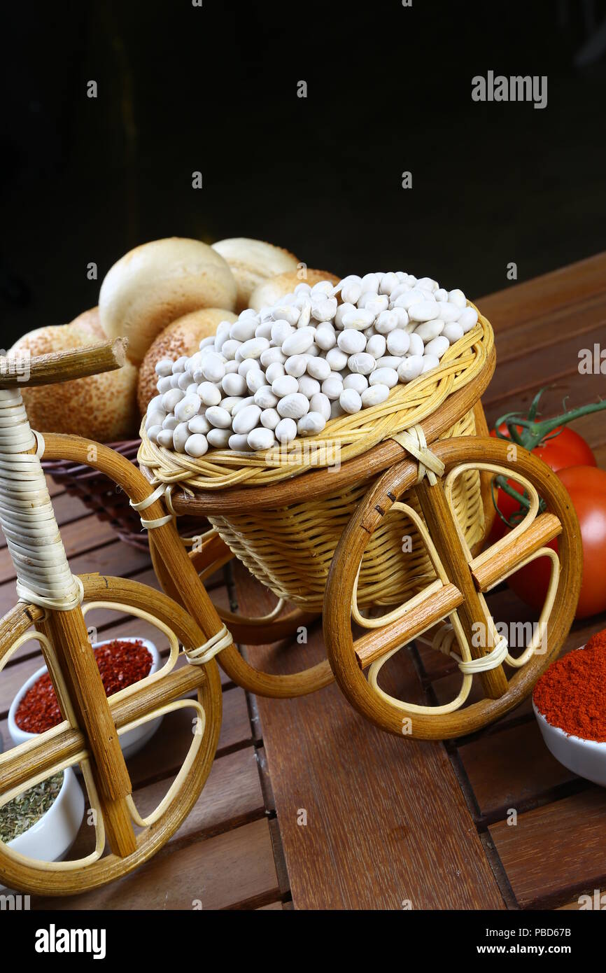 white beans on the wooden bike wicker basket Stock Photo - Alamy