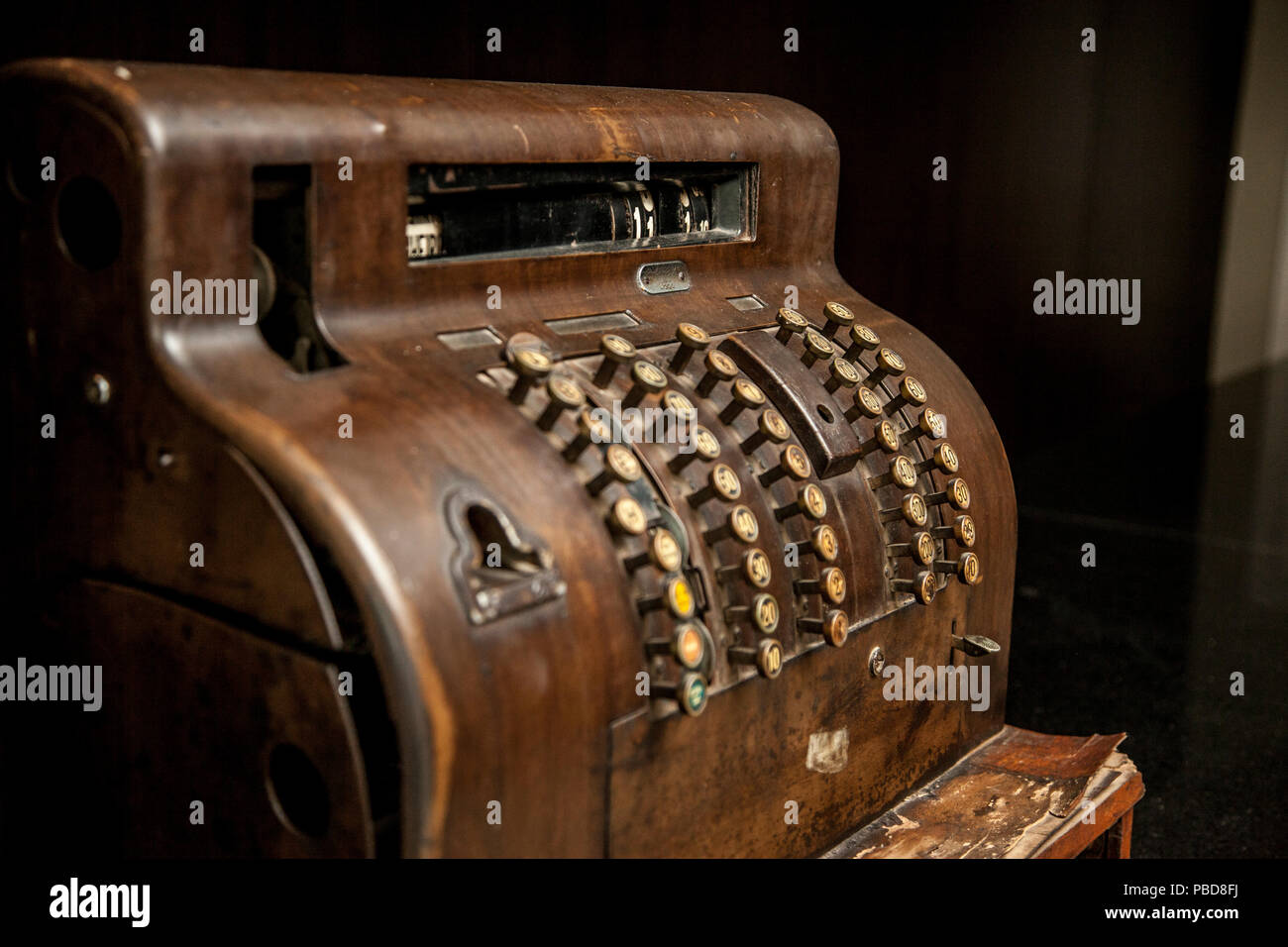 Vintage cash register on a black background Stock Photo - Alamy