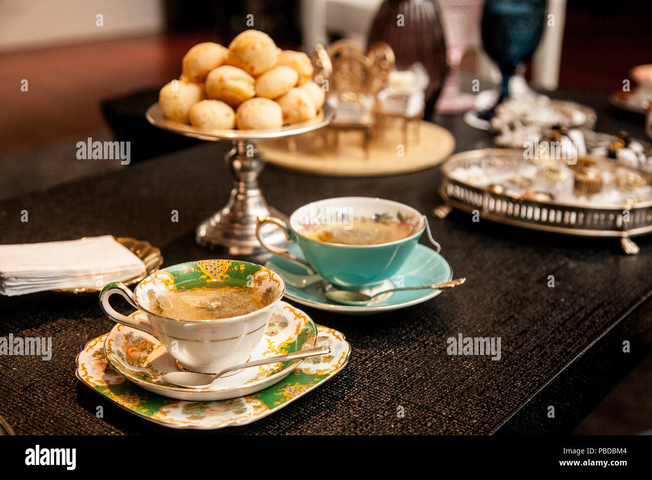 elegant tea cup on a dark wooden table. fancy afternoon tea concept ...