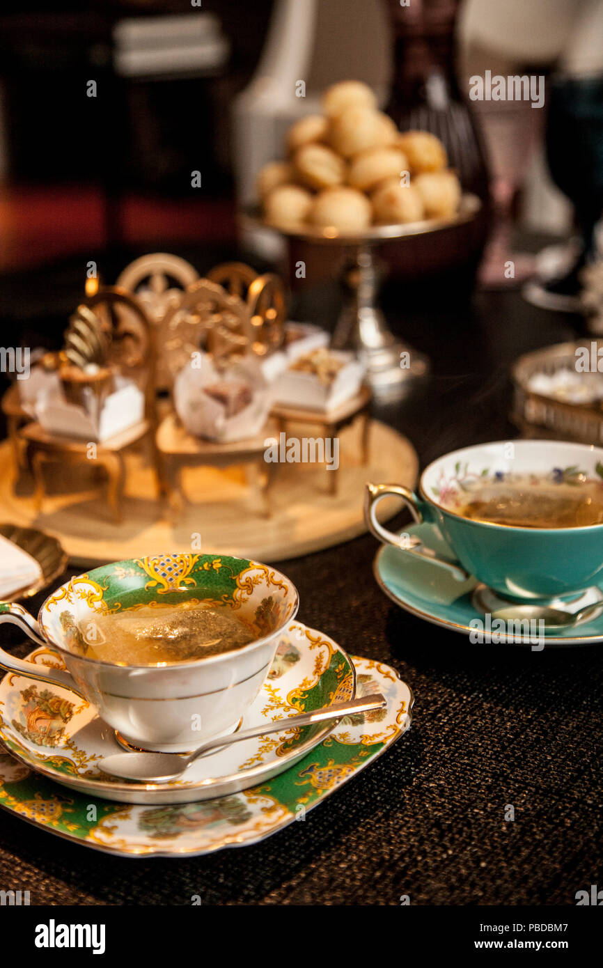 elegant tea cup on a dark wooden table. fancy afternoon tea concept ...