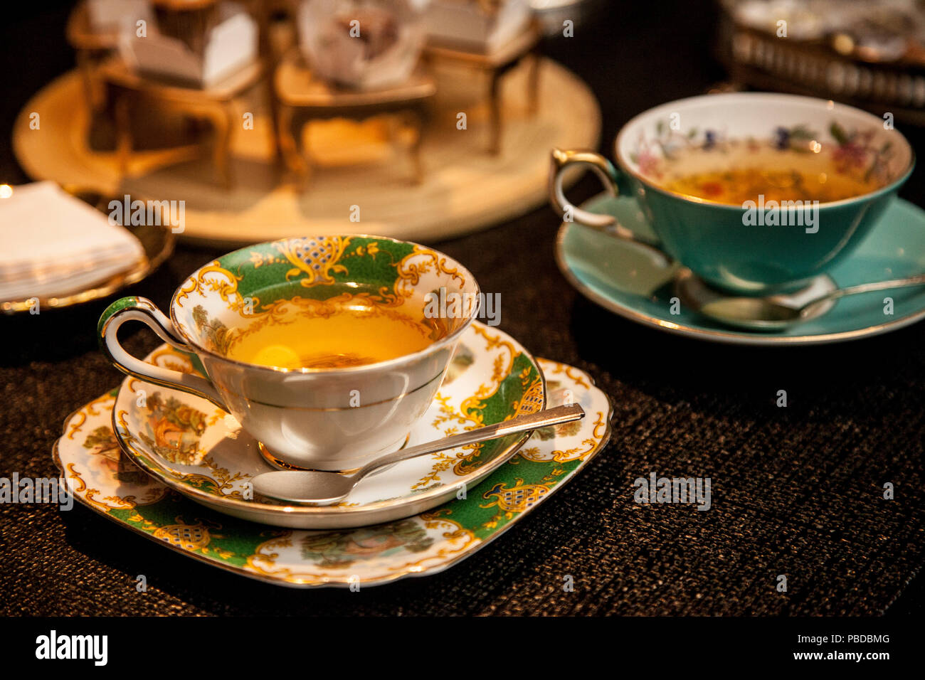 elegant tea cup on a dark wooden table. fancy afternoon tea concept ...