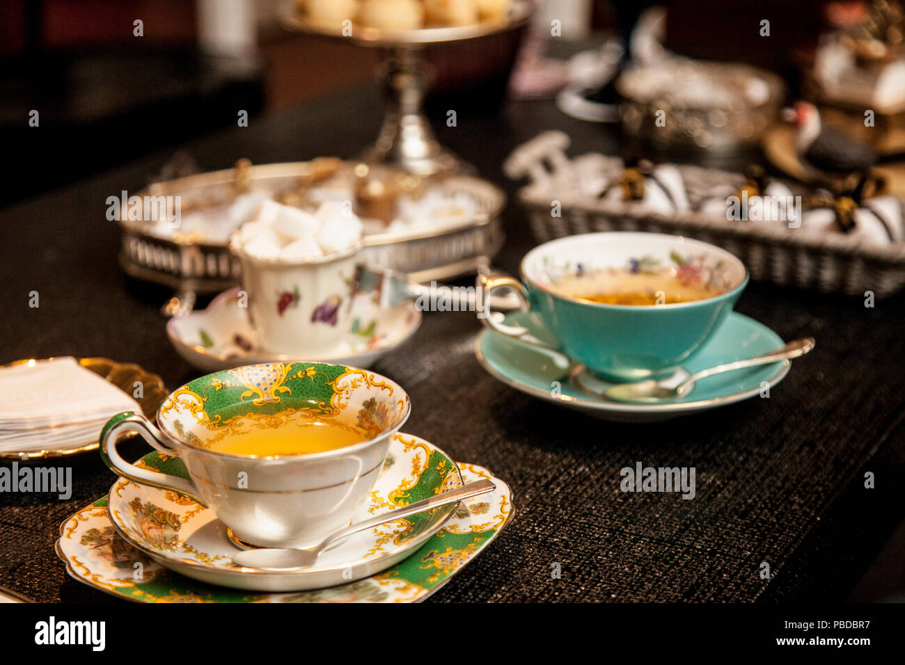 elegant tea cup on a dark wooden table. fancy afternoon tea concept ...