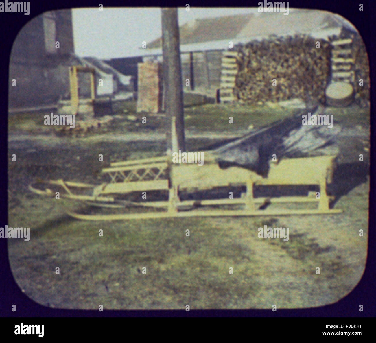 1316 Siberian sledge; full side view with well and large woodpile in ...