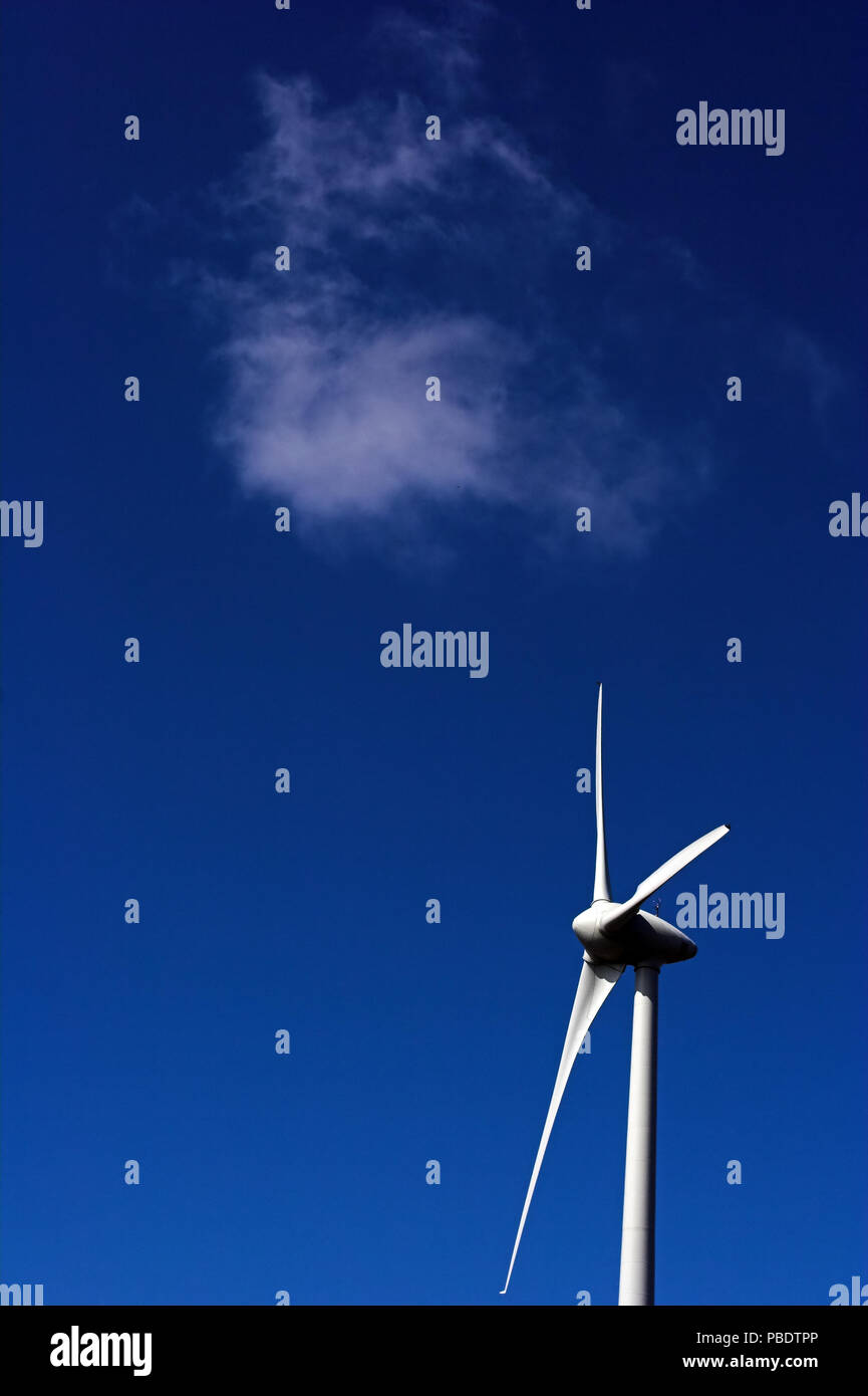 Minimalist composition with wind turbine, cloud and deep blue sky Stock ...