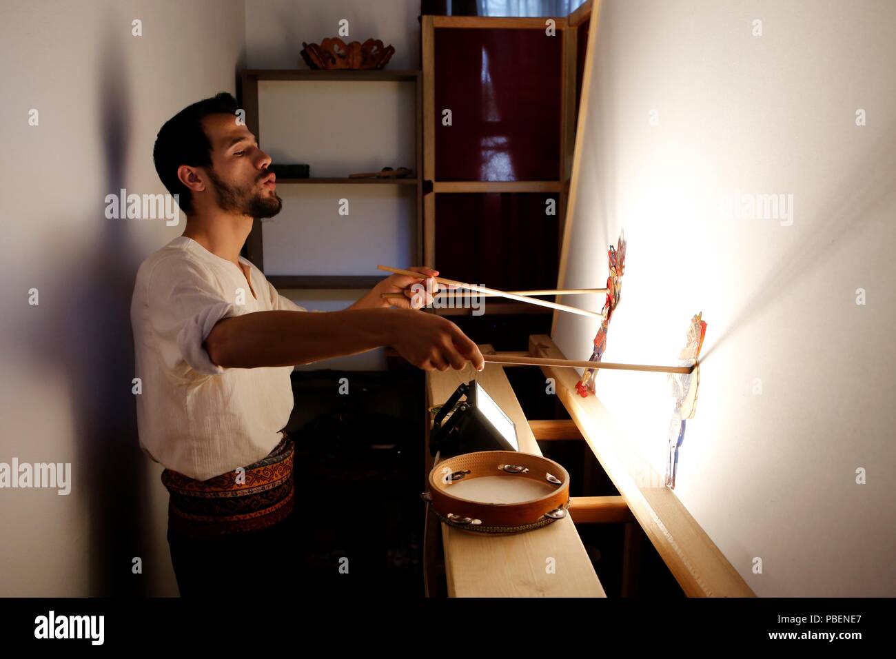 Ankara, Turkey. 25th July, 2018. An artist controls shadow puppets ...