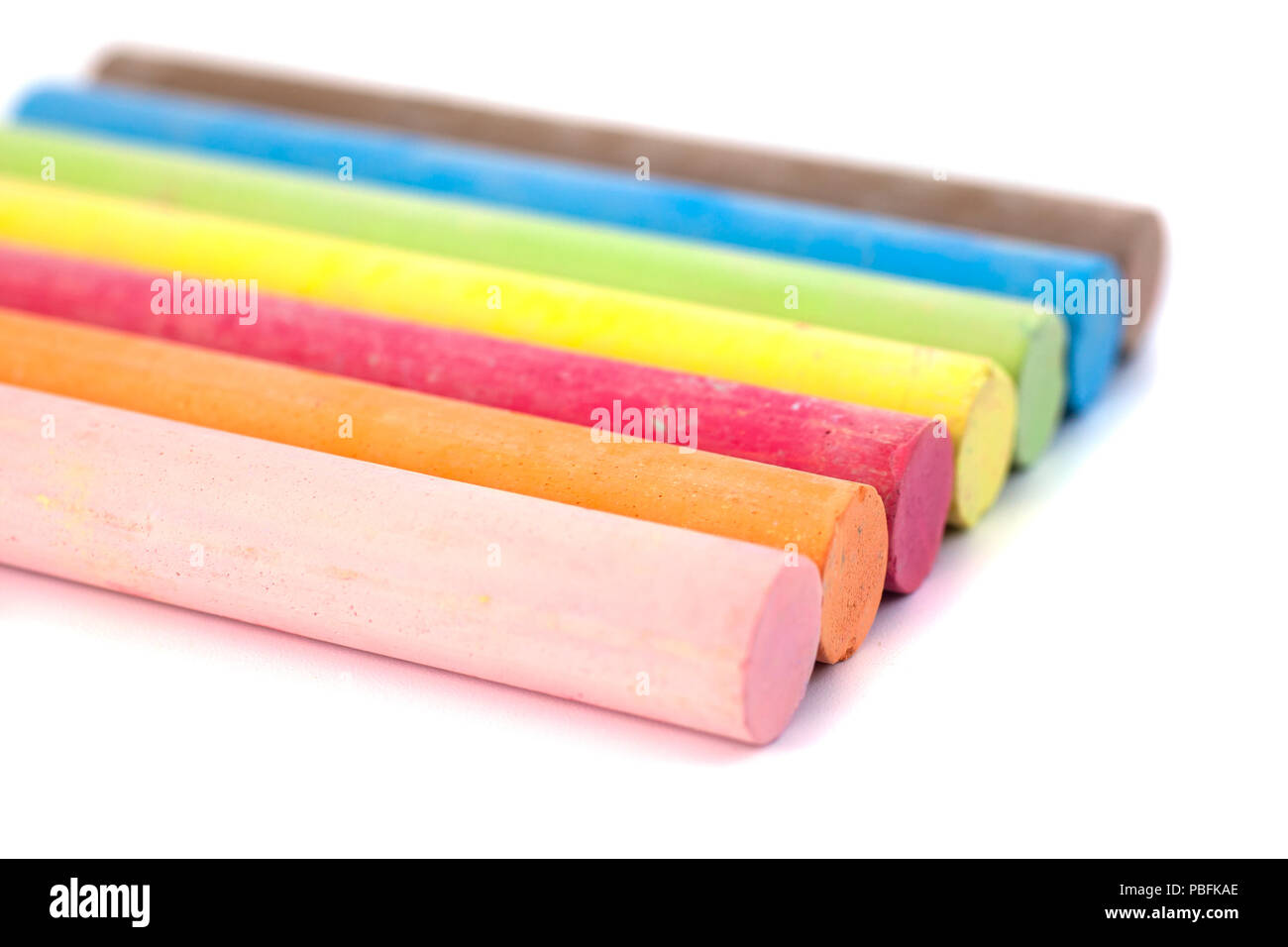 Colored chalks on white background with soft shadows Stock Photo - Alamy