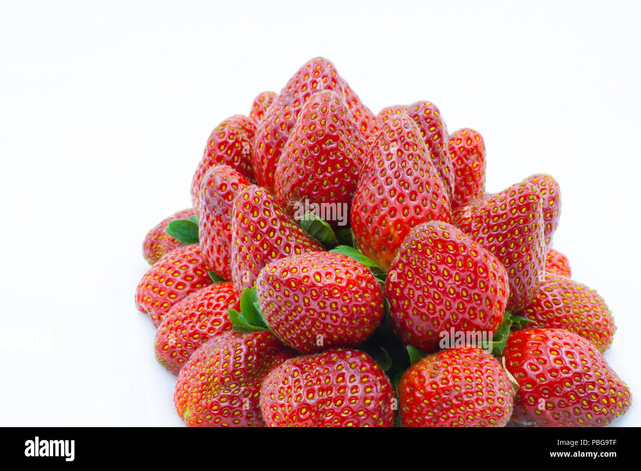 Pile strawberries isolated on a white background Stock Photo - Alamy