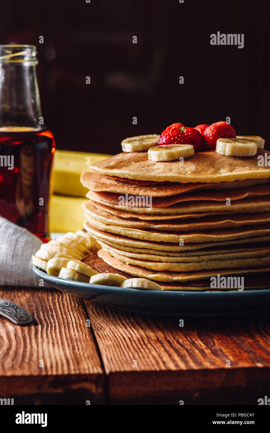 Homemade Pancakes with Maple Syrup, Strawberries and Banana. Vertical ...