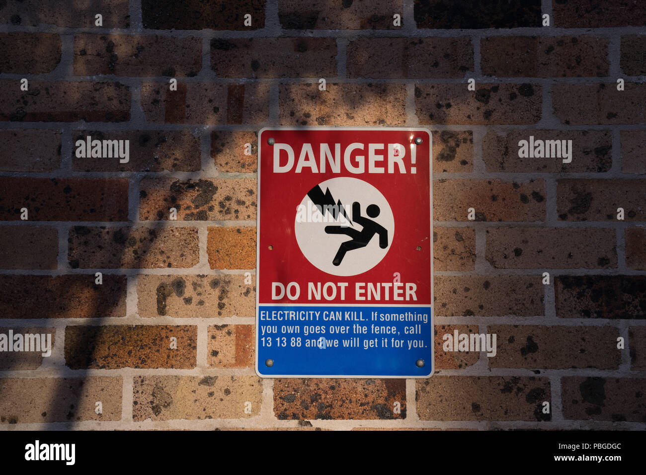 Danger, do not enter sign and symbol on brick wall Stock Photo - Alamy