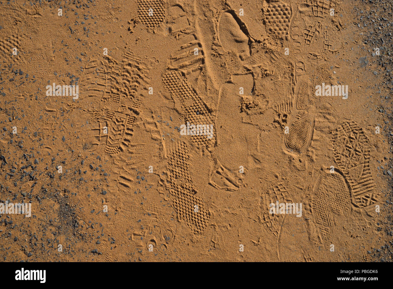 texture of shoes foot prints on golden sand background Stock Photo - Alamy