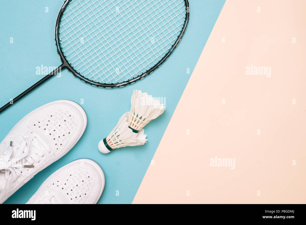 Shuttlecock and badminton racket with sport shoes on pastel color ...