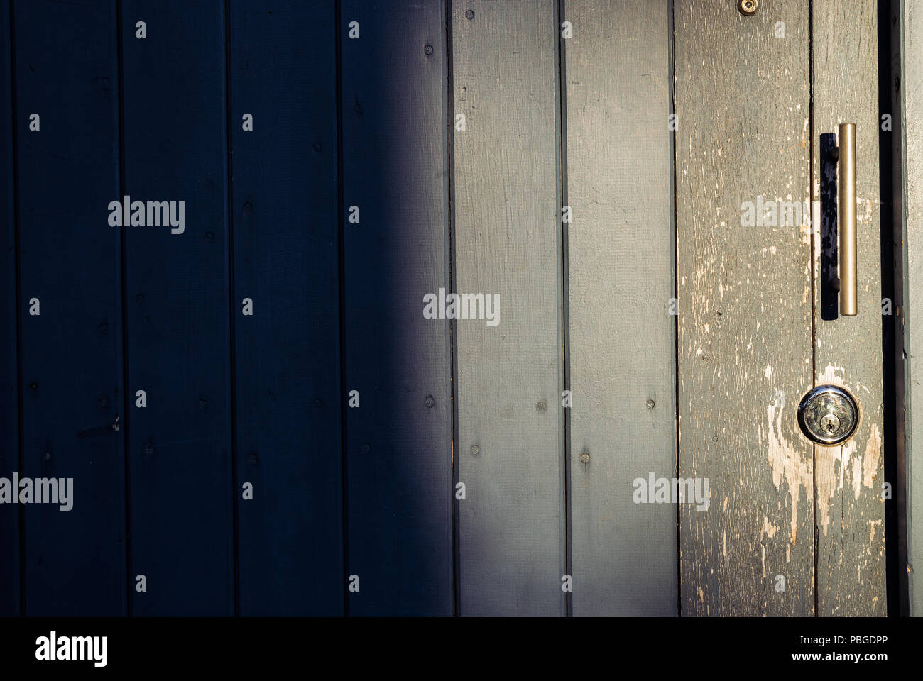 texture of vintage wooden door with handle and warm light and shadow ...