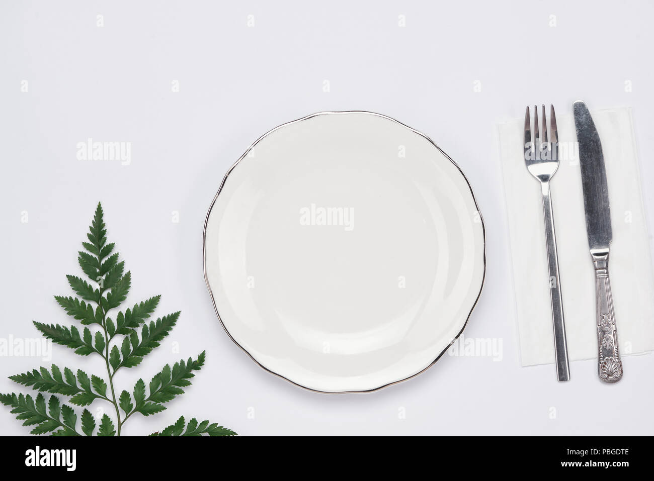 Dinner plate setting top view. Empty plate and silverware set on wooden ...
