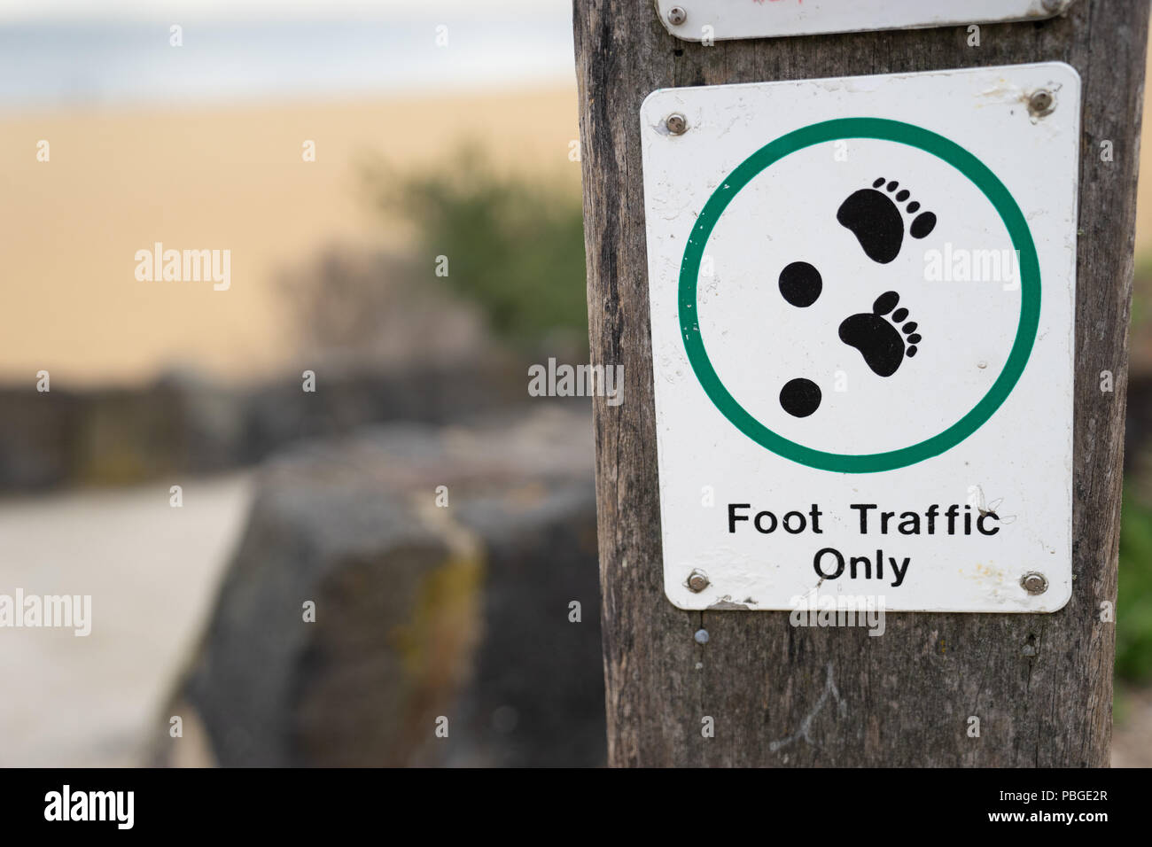 Foot Traffic only sign and symbol on wooden pole in beach path way walk ...