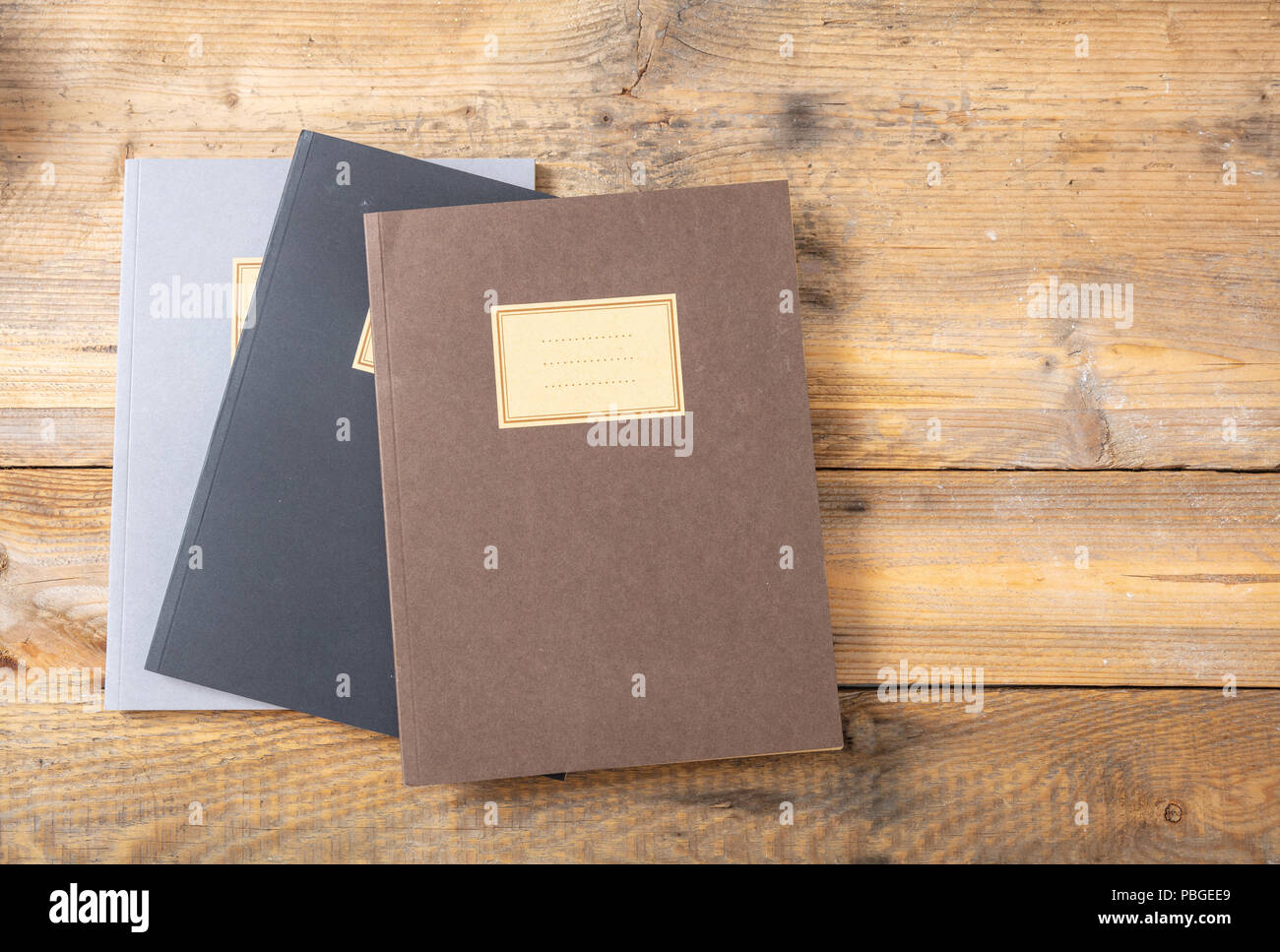 School notebooks stack, old fashioned, isolated on wooden background ...