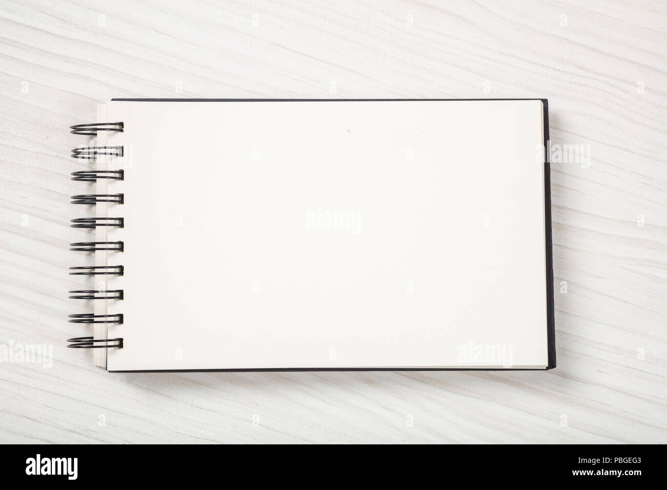 Open notebook, isolated on white wooden background, copy space, top ...