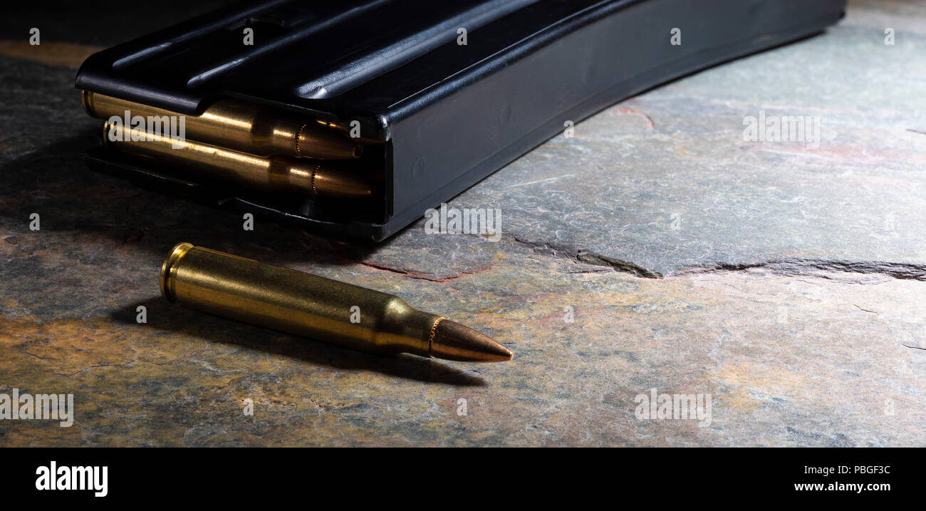 Cartridges loaded in an AR-15 magazine with a single one outside Stock ...