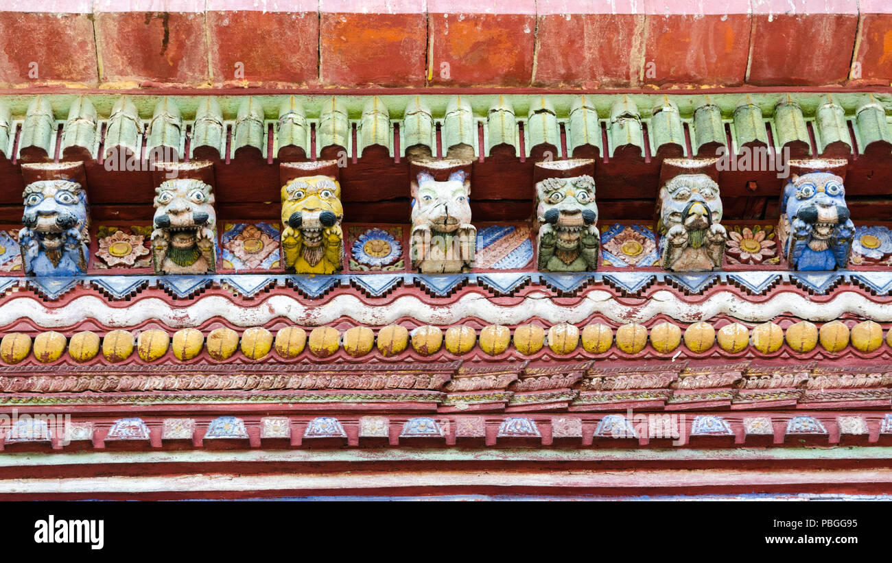 Detail of colorful wood carved faces of Changu Narayan temple, Nepal ...