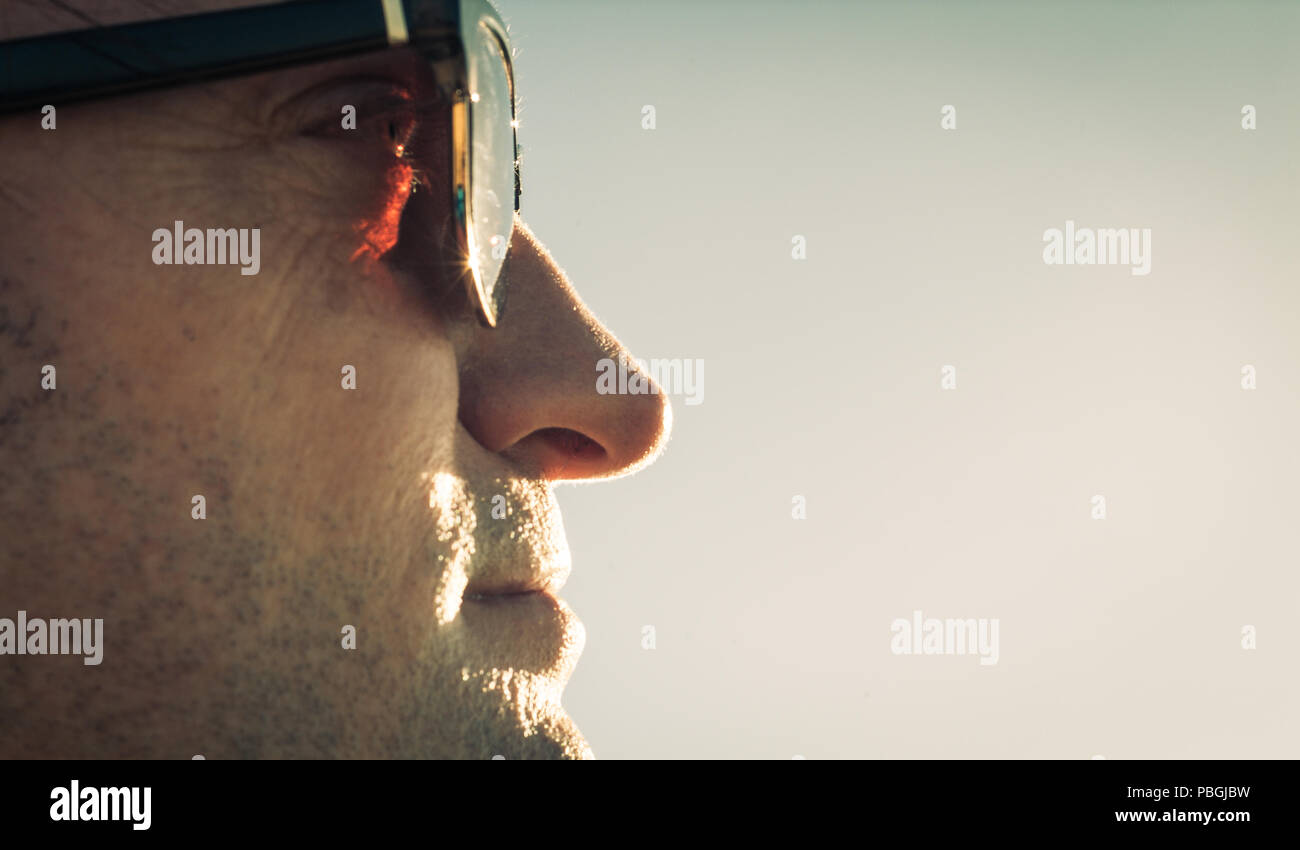closeup photo of a man facing the sun in sunglasses Stock Photo - Alamy