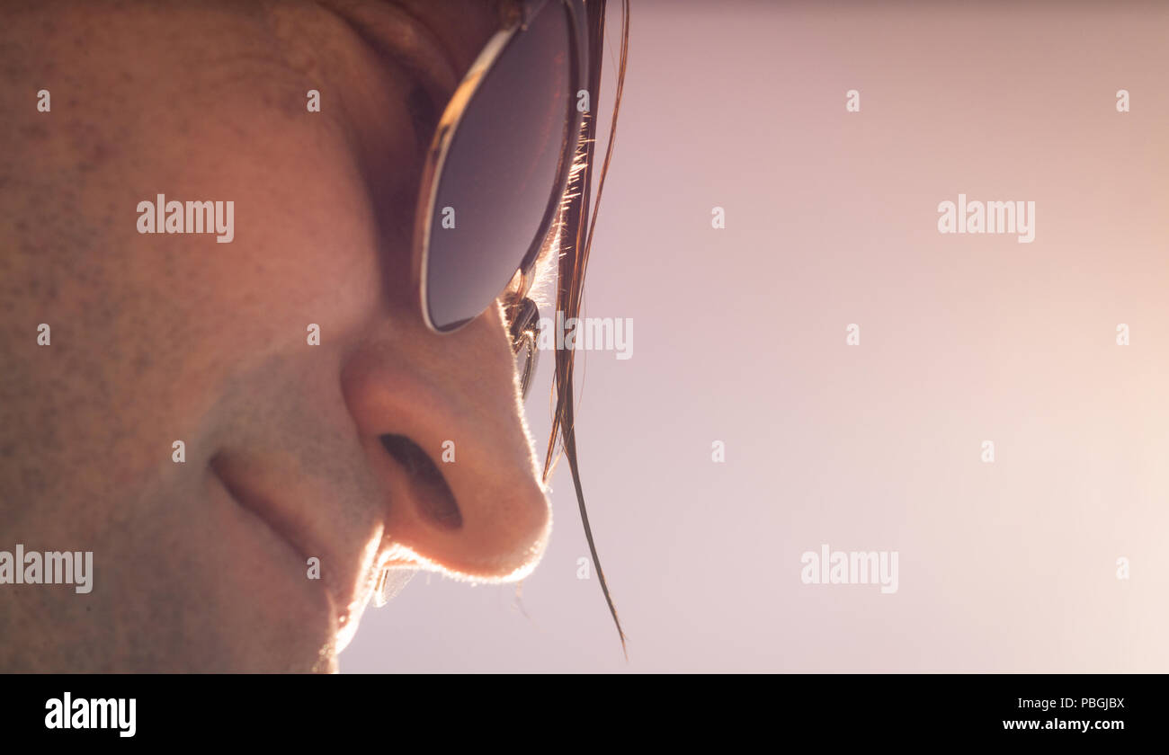 closeup photo of a man facing the sun in sunglasses Stock Photo - Alamy