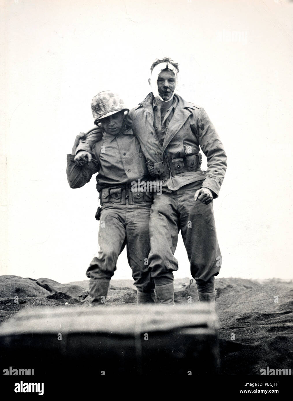 World War II Photo - A buddy helps a fellow marine after being wounded ...