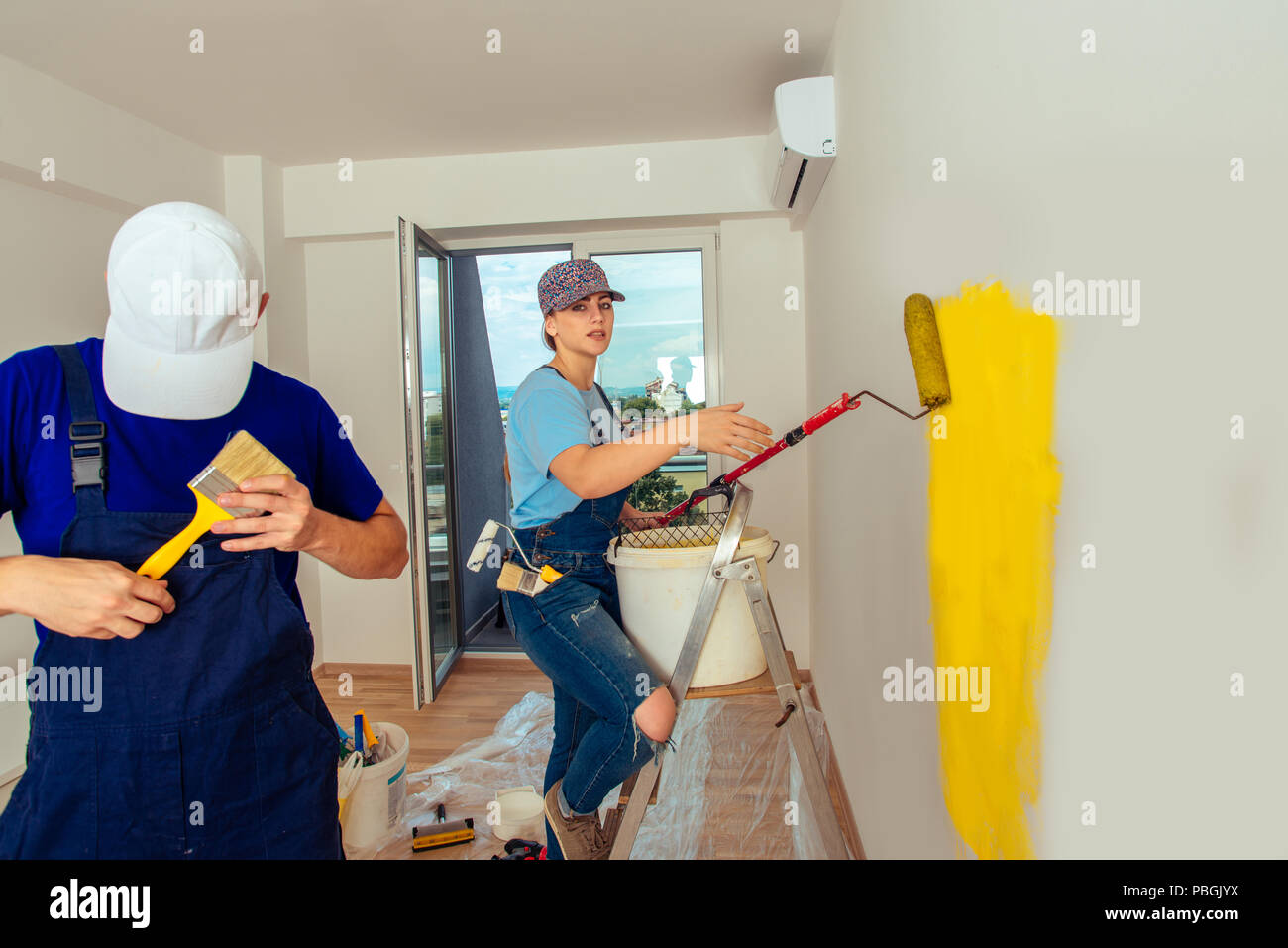 Couple renovate their living room from white to yellow with paint stick ...