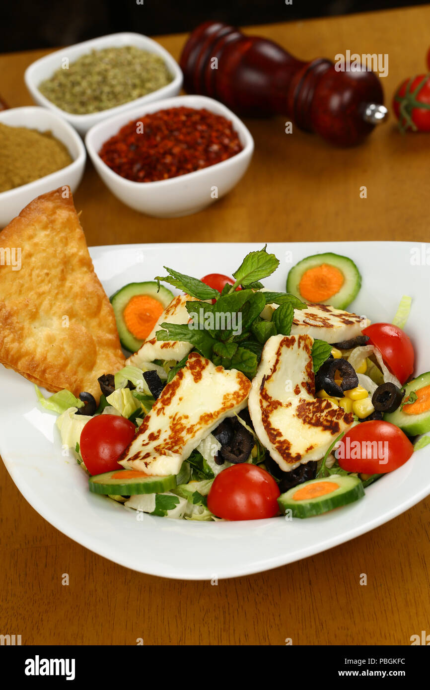 Healthy salad with tomato and halloumi cheese Stock Photo - Alamy