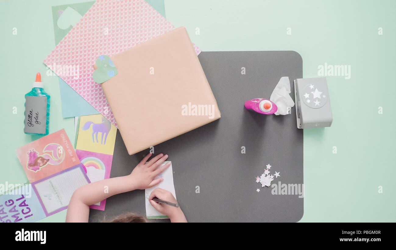 Decorating present for kids birthday with craft paper Stock Photo - Alamy