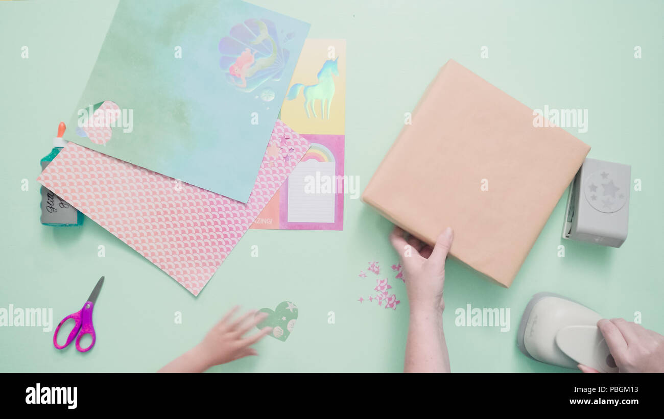 Decorating present for kids birthday with craft paper Stock Photo - Alamy