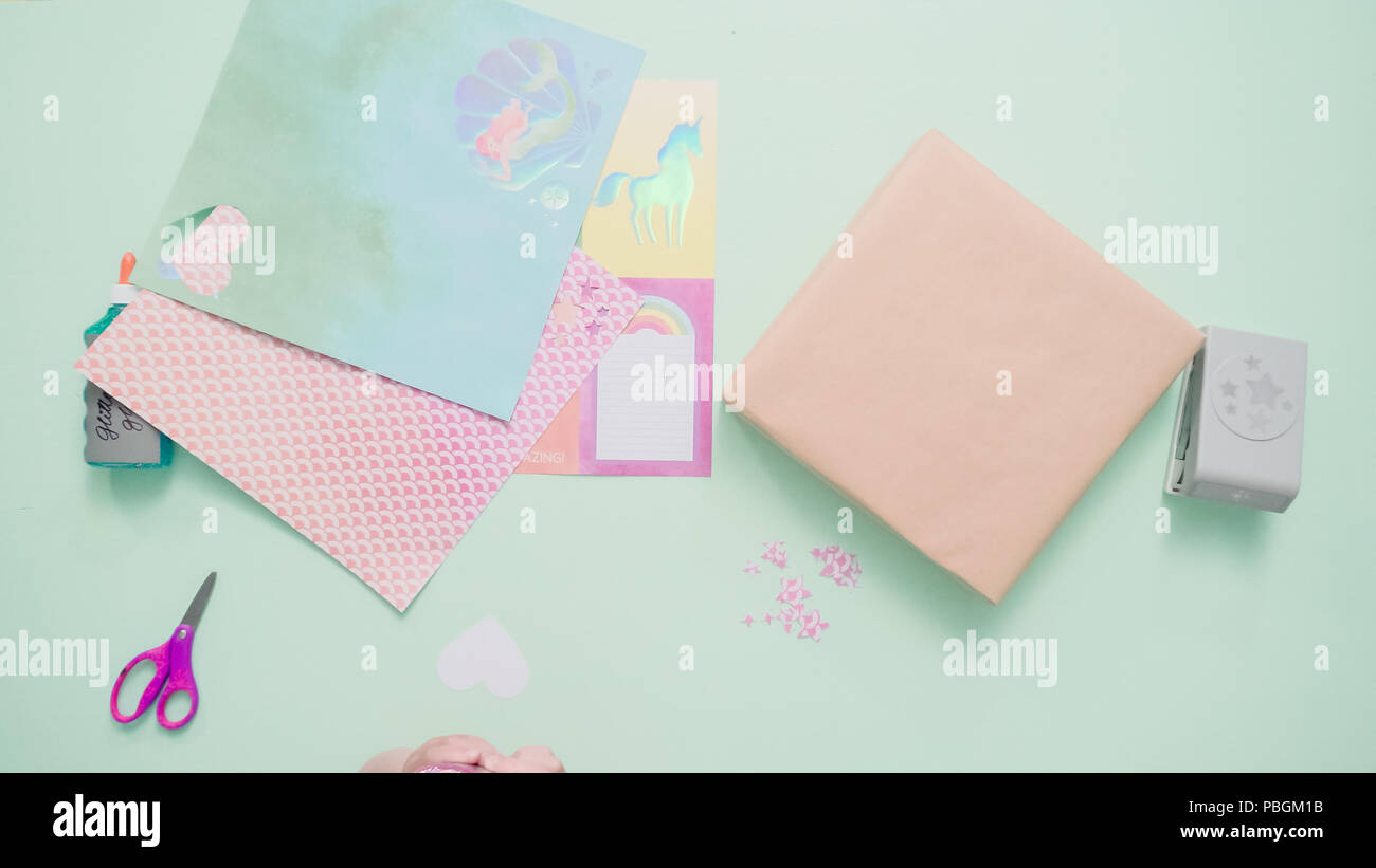 Decorating present for kids birthday with craft paper Stock Photo - Alamy