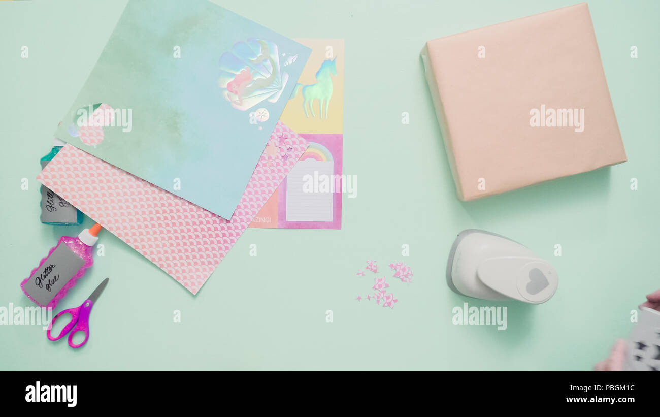 Decorating present for kids birthday with craft paper Stock Photo - Alamy